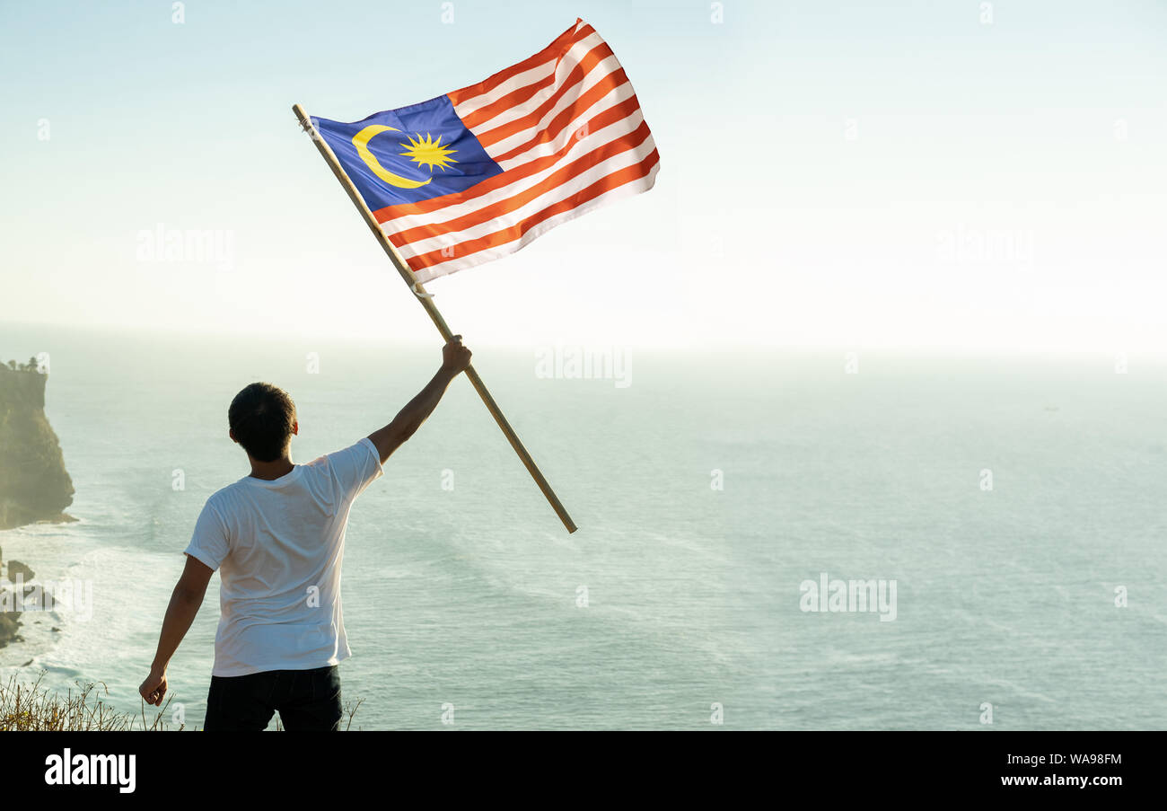 asian man with malaysia flag standing proudly on top of hill Stock ...