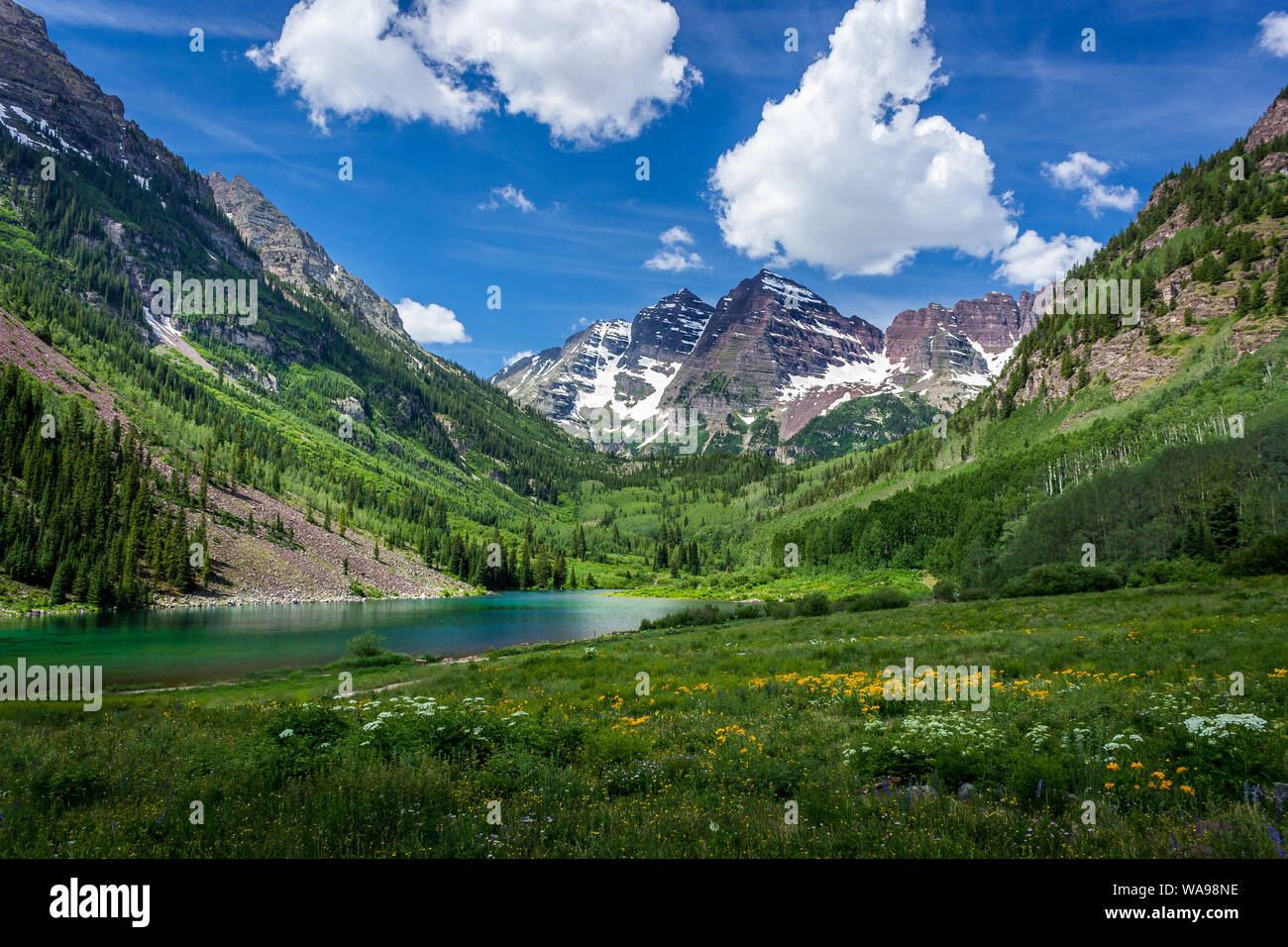 Majestic Maroon Bells peaks and Maroon Lake on a sunny day and blue sky ...