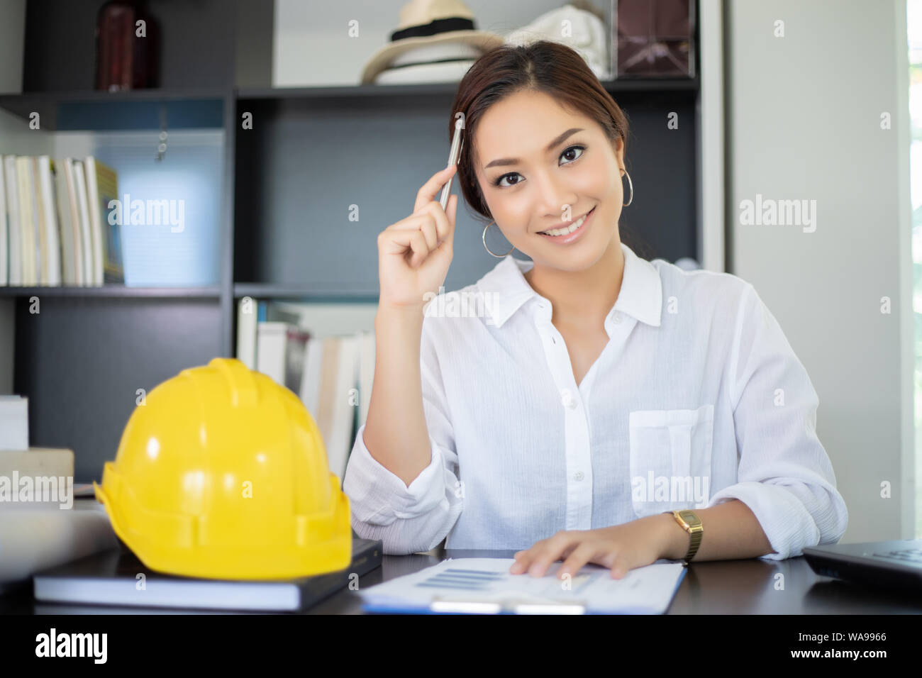 Female engineers are thinking to create new jobs and are smiling and ...
