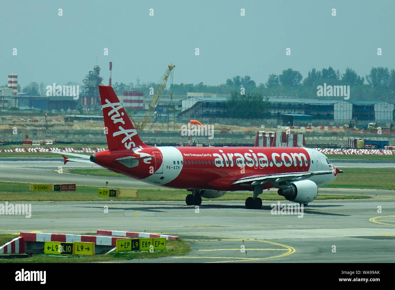 Singapore - Mar 28, 2019. PK-AZH Indonesia AirAsia Airbus A320 taxiing on runway of Singapore ...