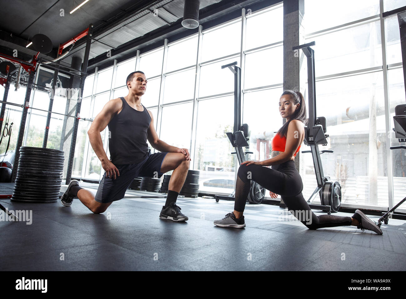 A muscular athletes doing workout at the gym. Gymnastics, training ...