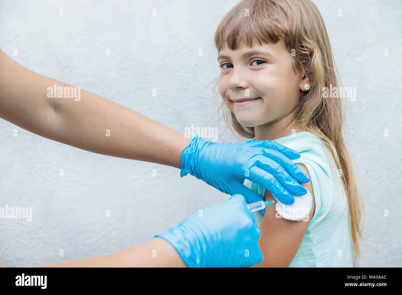 The doctor gives the child an injection in the arm. Selective focus ...