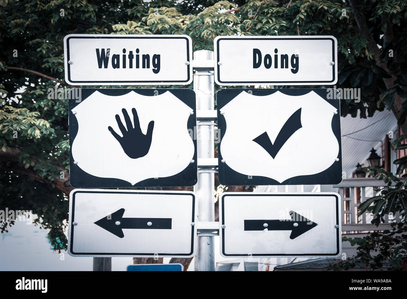 Street Sign the Direction Way to Doing versus Waiting Stock Photo - Alamy