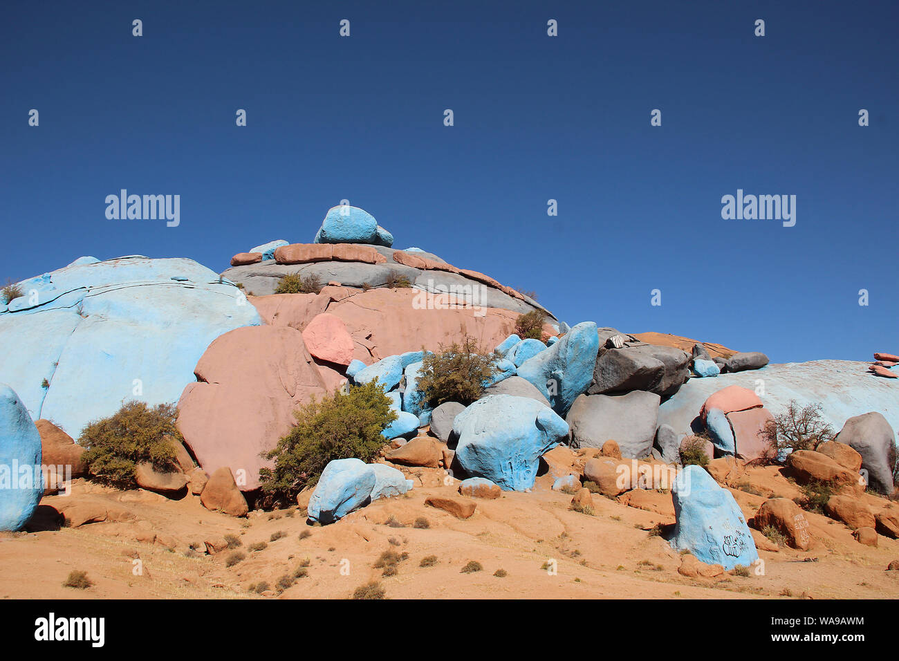 Blue and red rocks in the middle of the dry Atlas mountains in Morocco ...