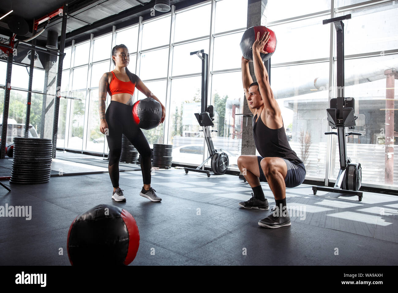 A muscular athletes doing workout at the gym. Gymnastics, training ...