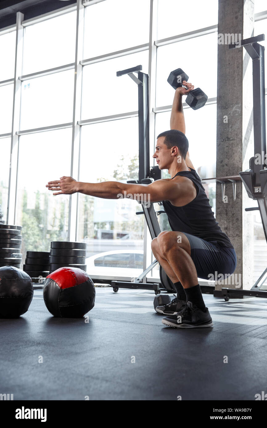 A muscular athlete doing workout at the gym. Gymnastics, training ...