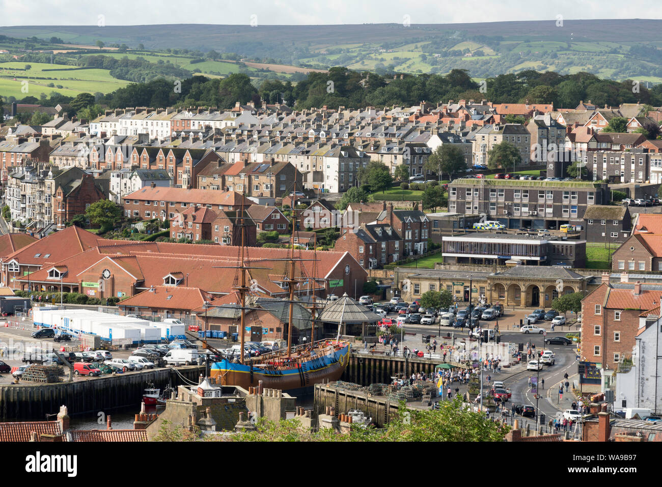 Whitby townscape with replica Captain Cook's ship Endeavour and rows of ...