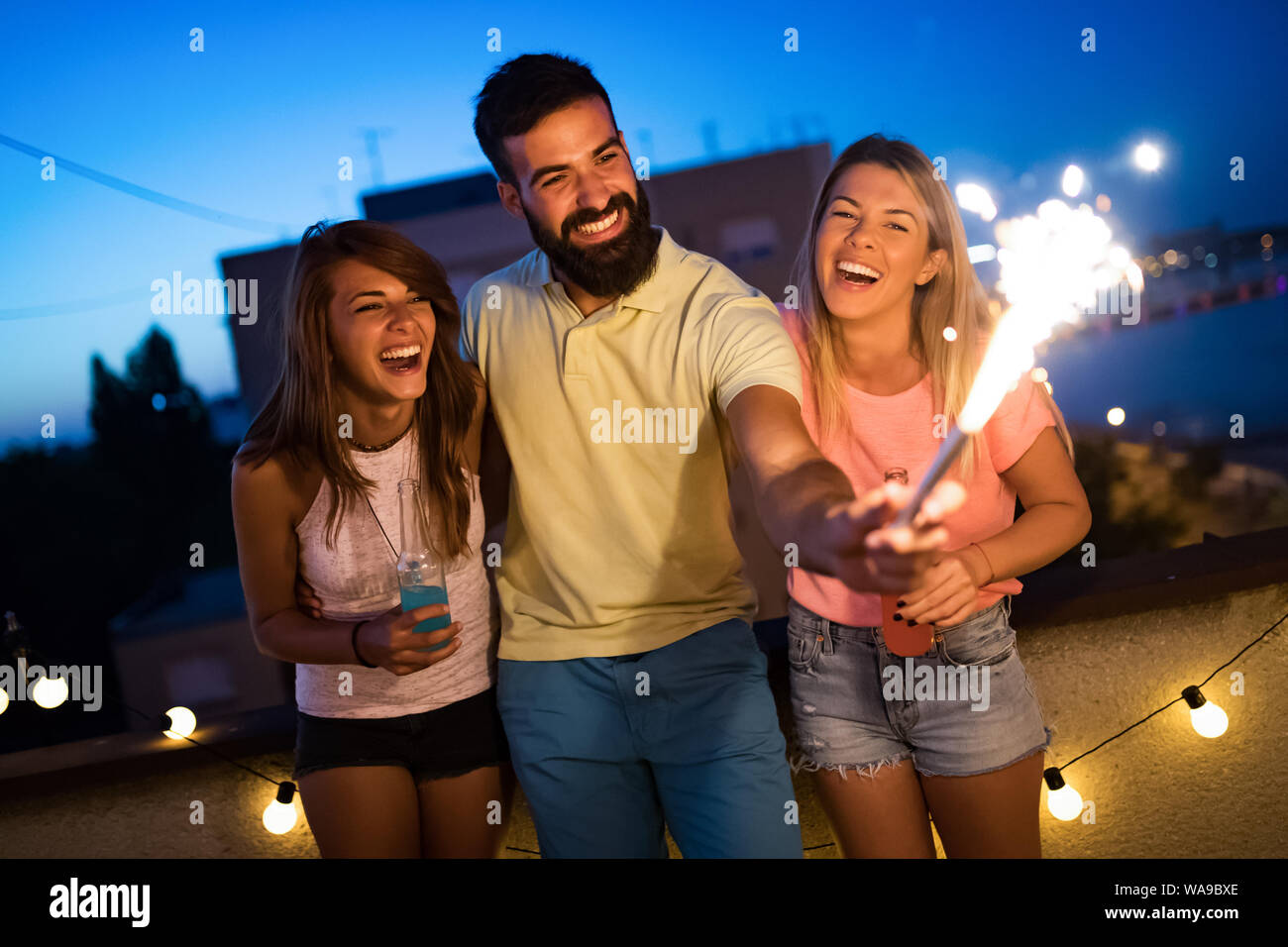 Group of happy friends having party on rooftop Stock Photo - Alamy