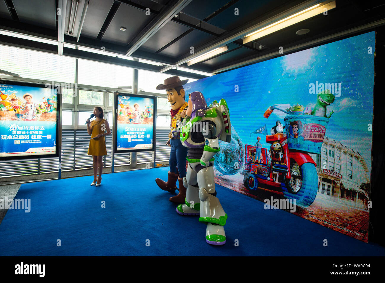 Entertainers dressed in Buzz Lightyear and Woody from Disney animated ...