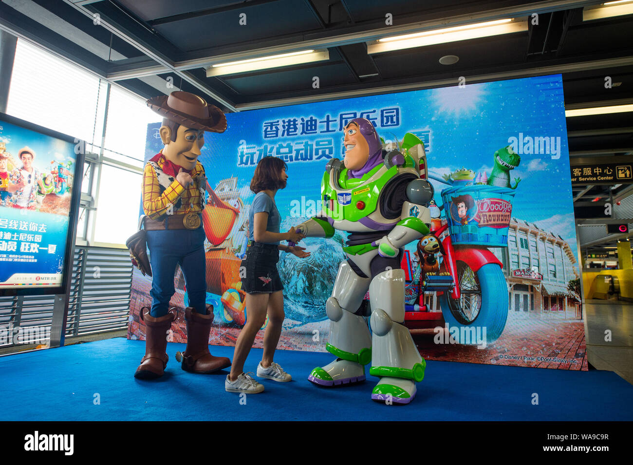 Entertainers dressed in Buzz Lightyear and Woody from Disney animated ...