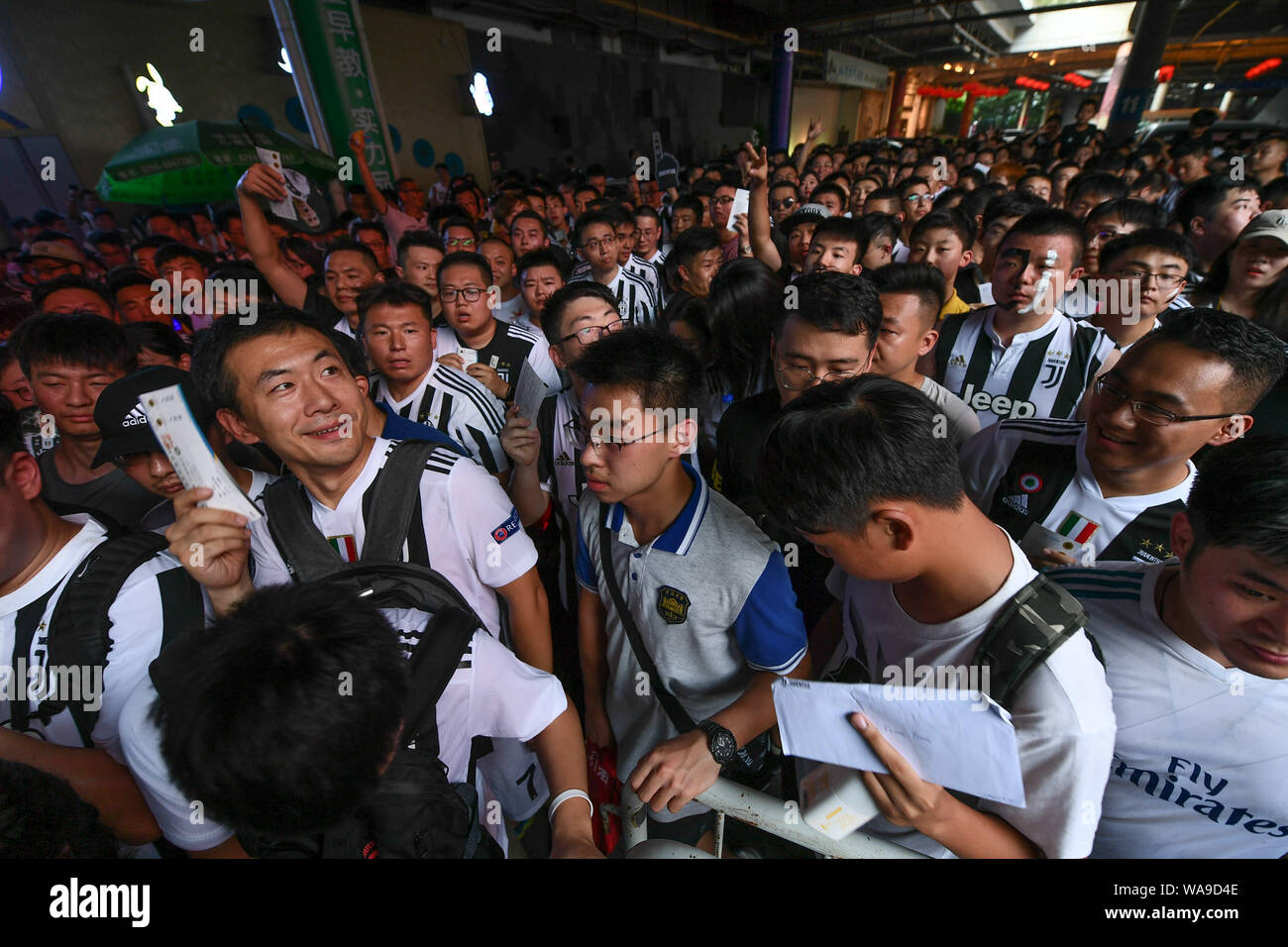 Fans shout and wave slogans to show support to Juventus F.C. during the ...