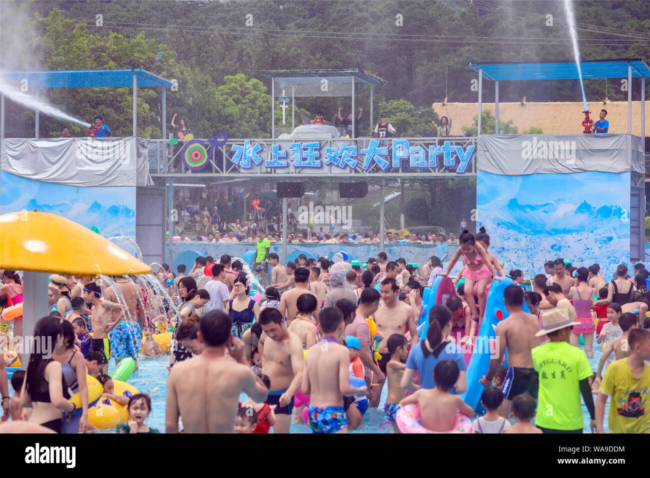 Chinese holidaymakers crowd a swimming pool at a water park on a ...