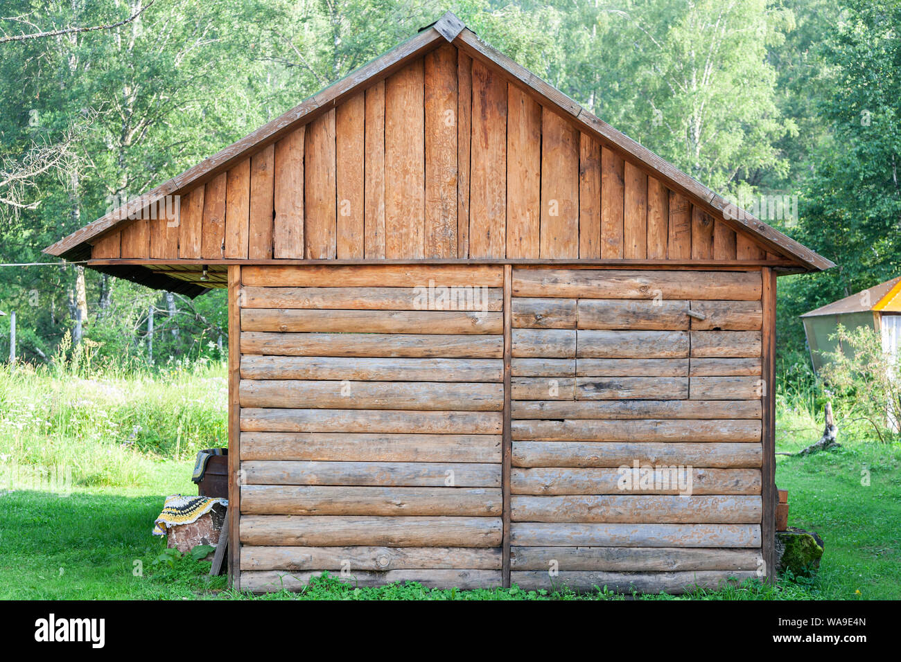Close-up of a summer wooden house with a small veranda in the ...