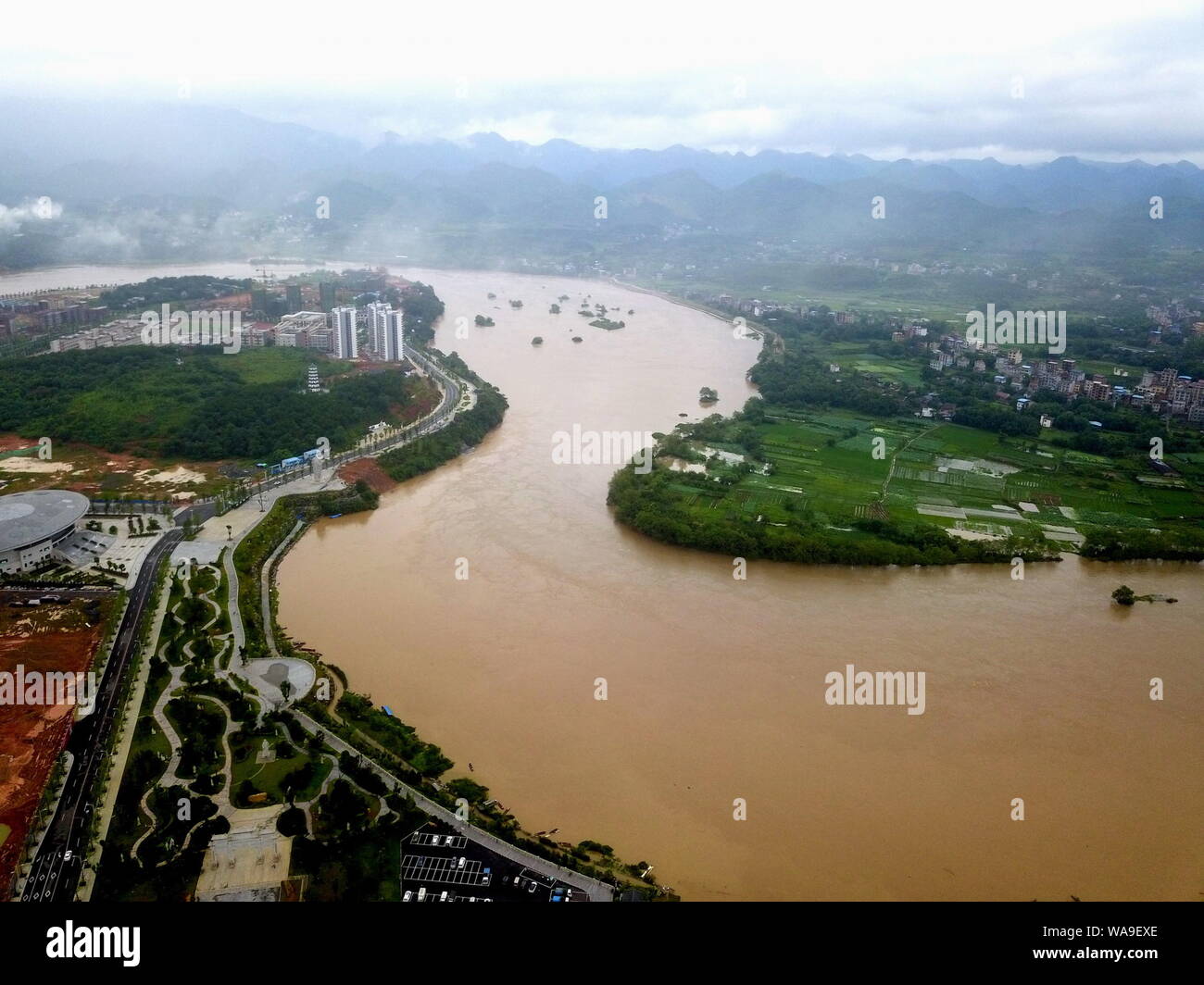 Residential buildings are surrounded by the flooded Xingjiang River ...