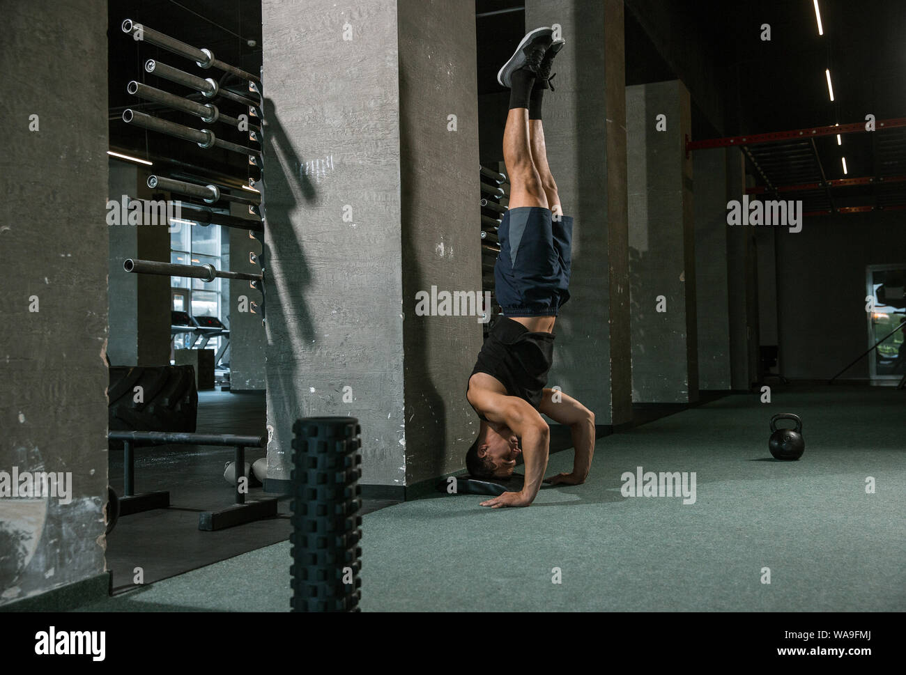 A muscular caucasian male athlete doing workout at the gym. Gymnastics ...