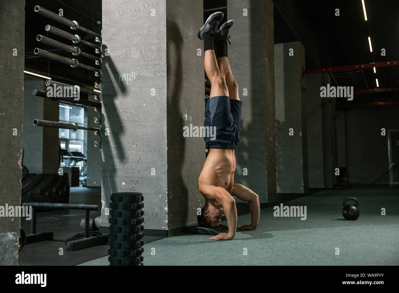 A muscular caucasian male athlete doing workout at the gym. Gymnastics ...