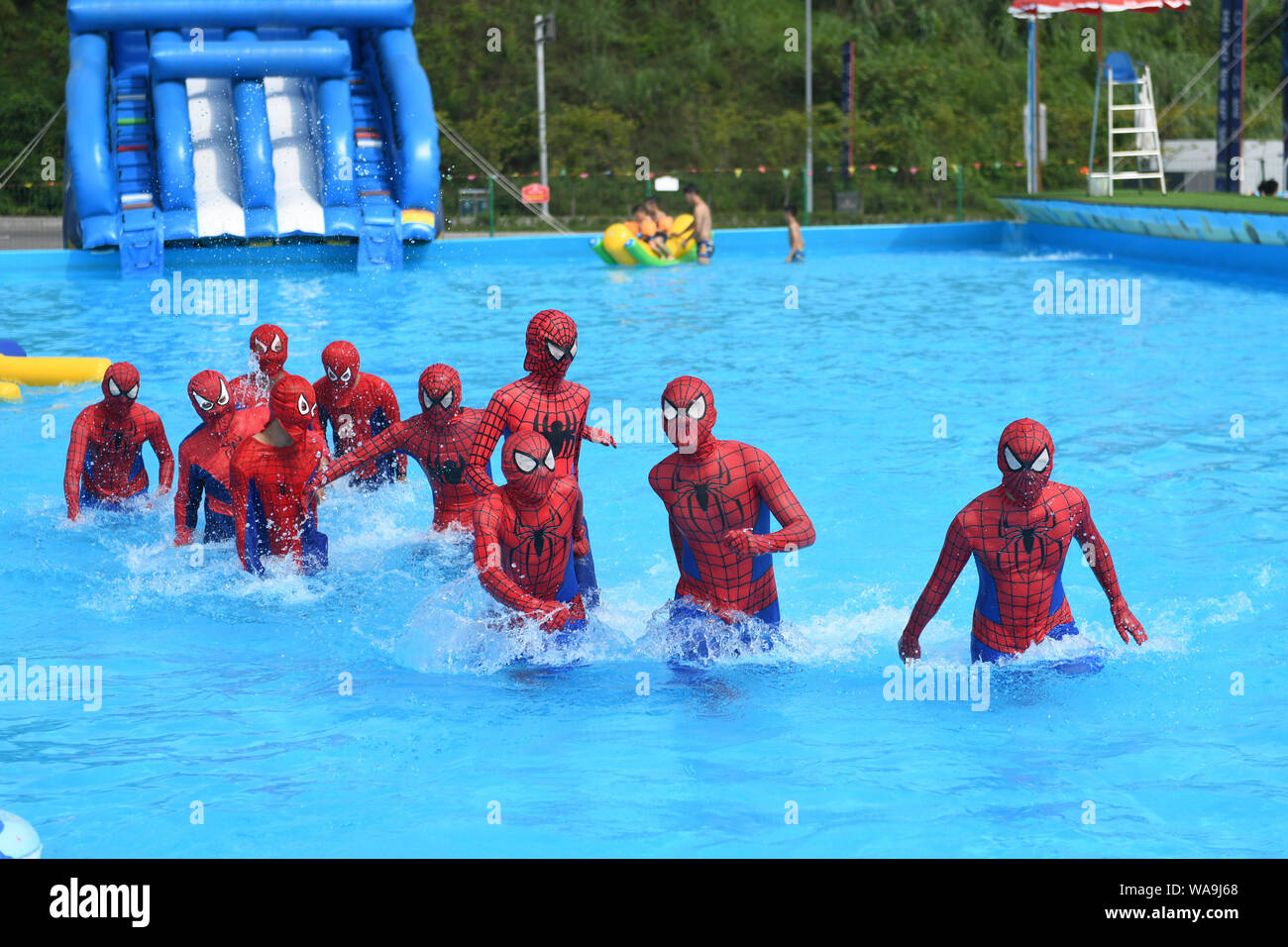 Chinese staff memers dressed as Spider-Man play in a swimming pool ...