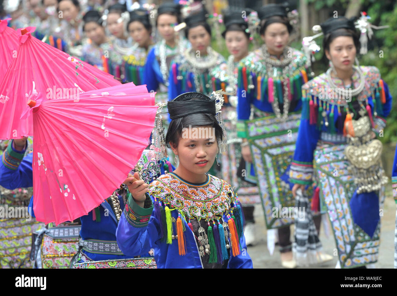 Chinese people of Dong ethnic group wearing traditional costumes and ...