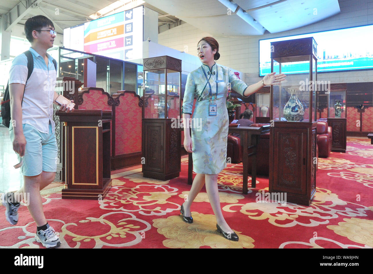 Chinese hostesses dressed in Cheongsam, a traditional Chinese dresses ...