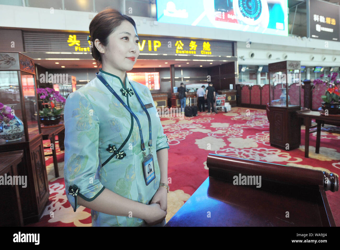 Chinese hostesses dressed in Cheongsam, a traditional Chinese dresses ...