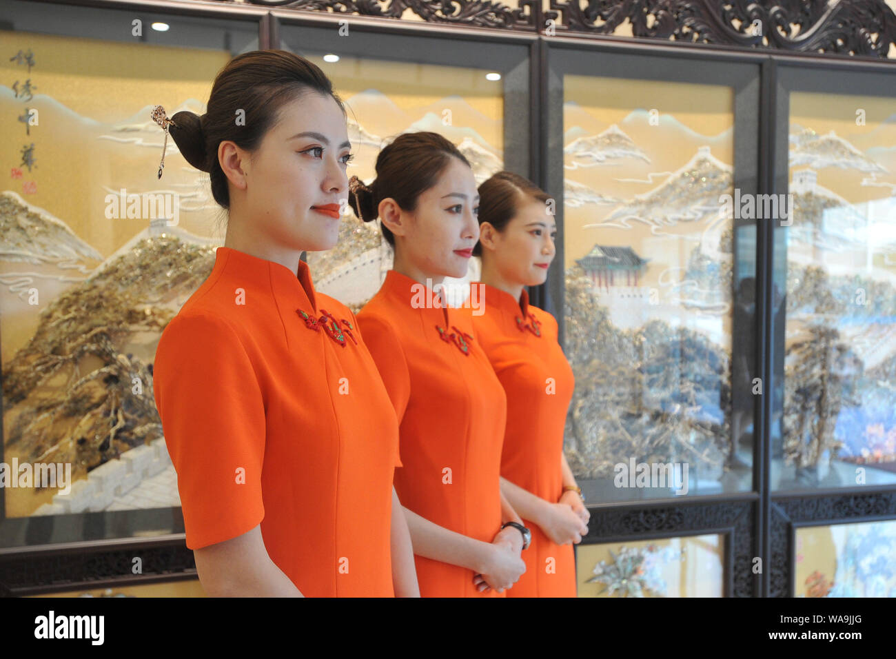 Chinese hostesses dressed in Cheongsam, a traditional Chinese dresses ...