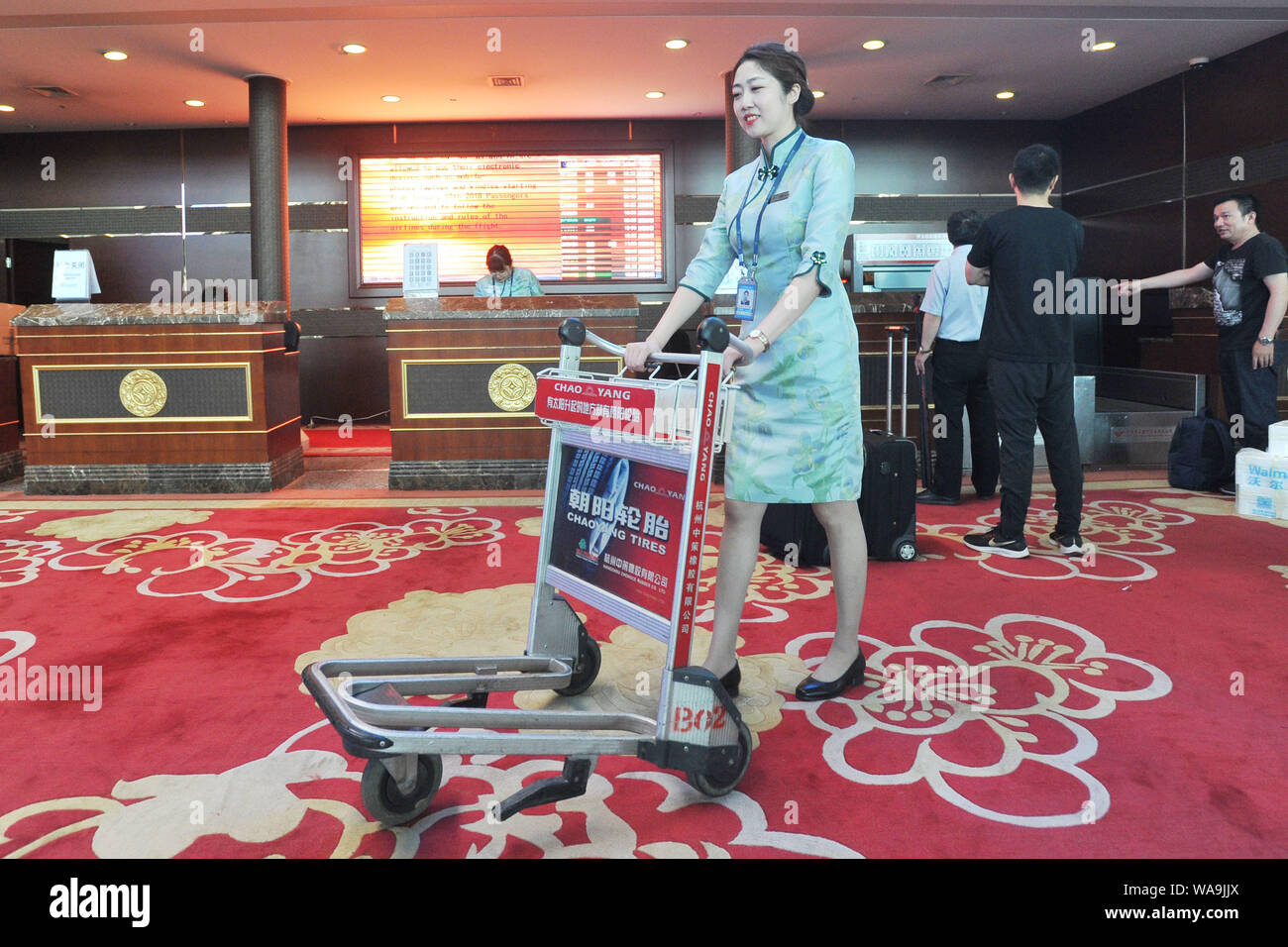 Chinese hostesses dressed in Cheongsam, a traditional Chinese dresses ...