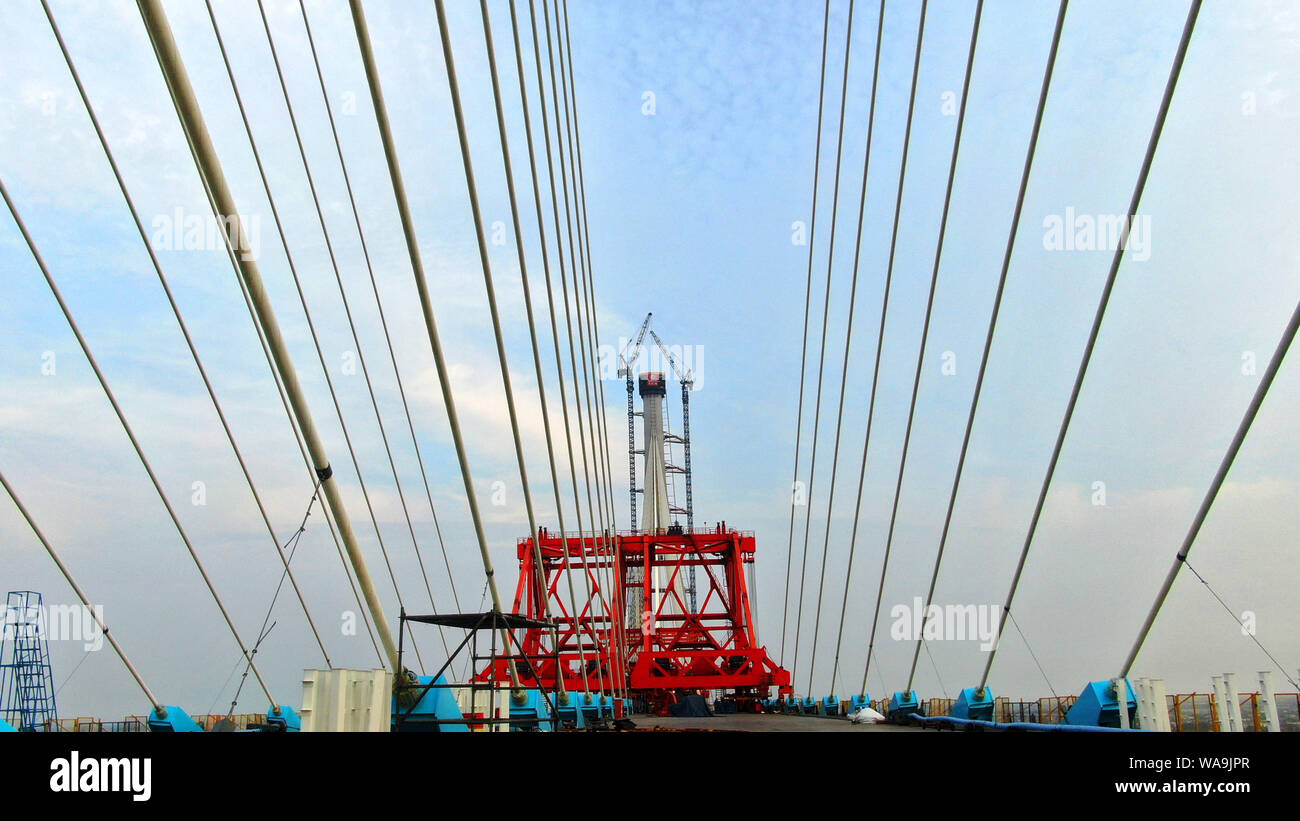 Chinese workers labor at the construction site of world's longest cable ...
