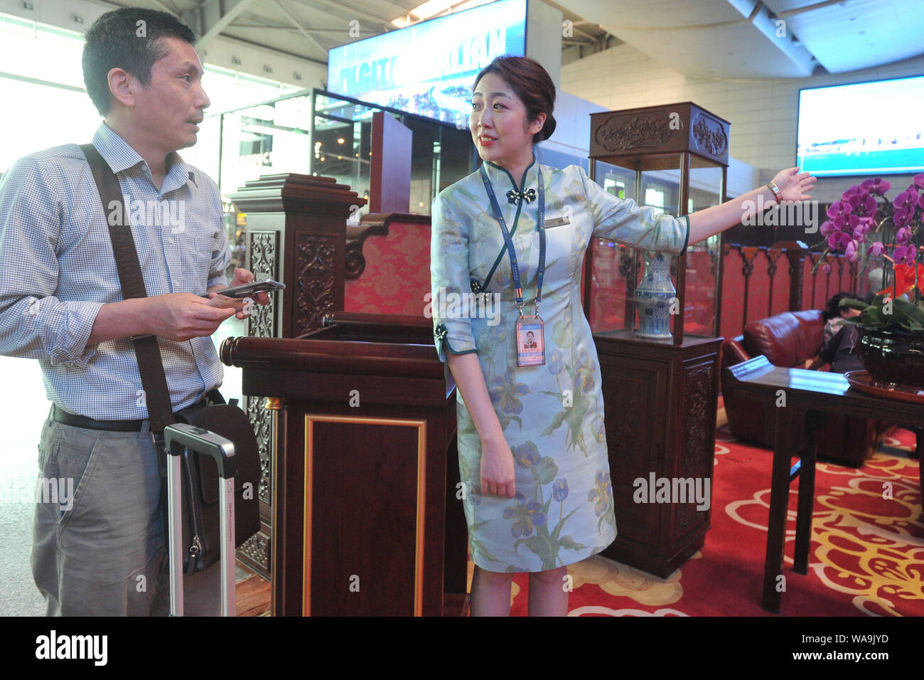 Chinese hostesses dressed in Cheongsam, a traditional Chinese dresses ...