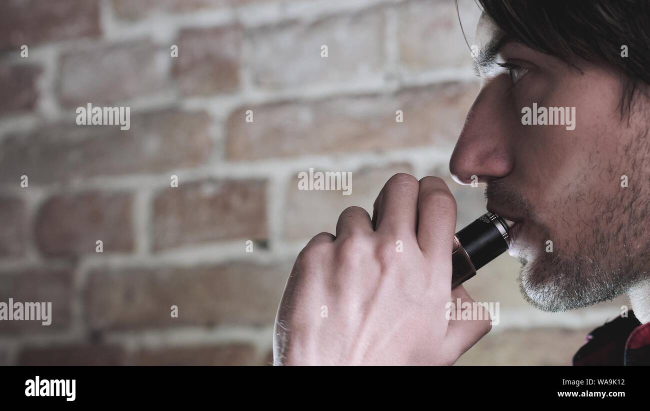 Young male man vaping in the street hi-res stock photography and images ...