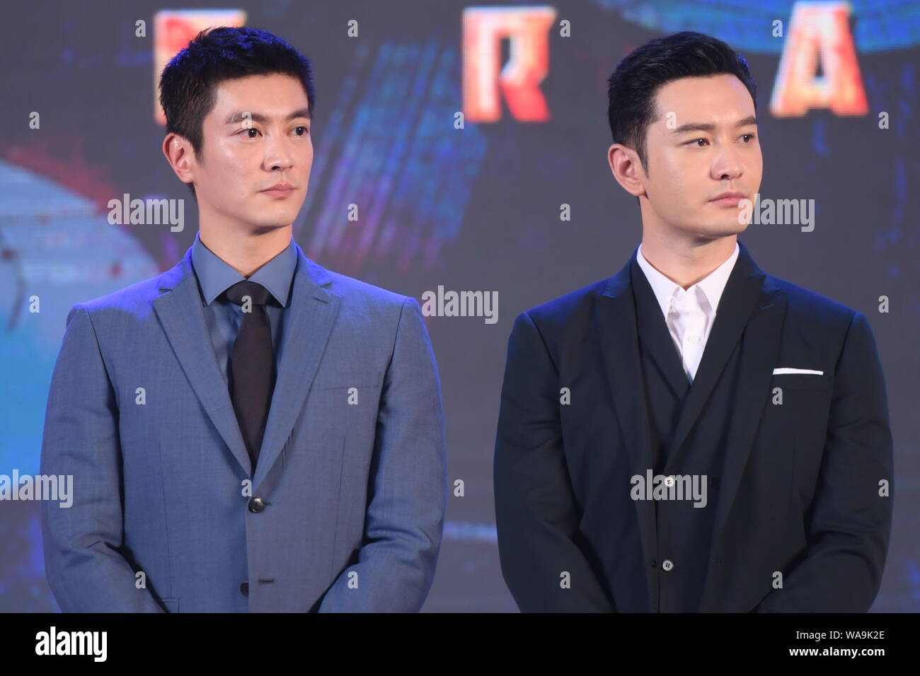 Chinese actors Du Jiang, left, and Huang Xiaoming attend a premiere ...