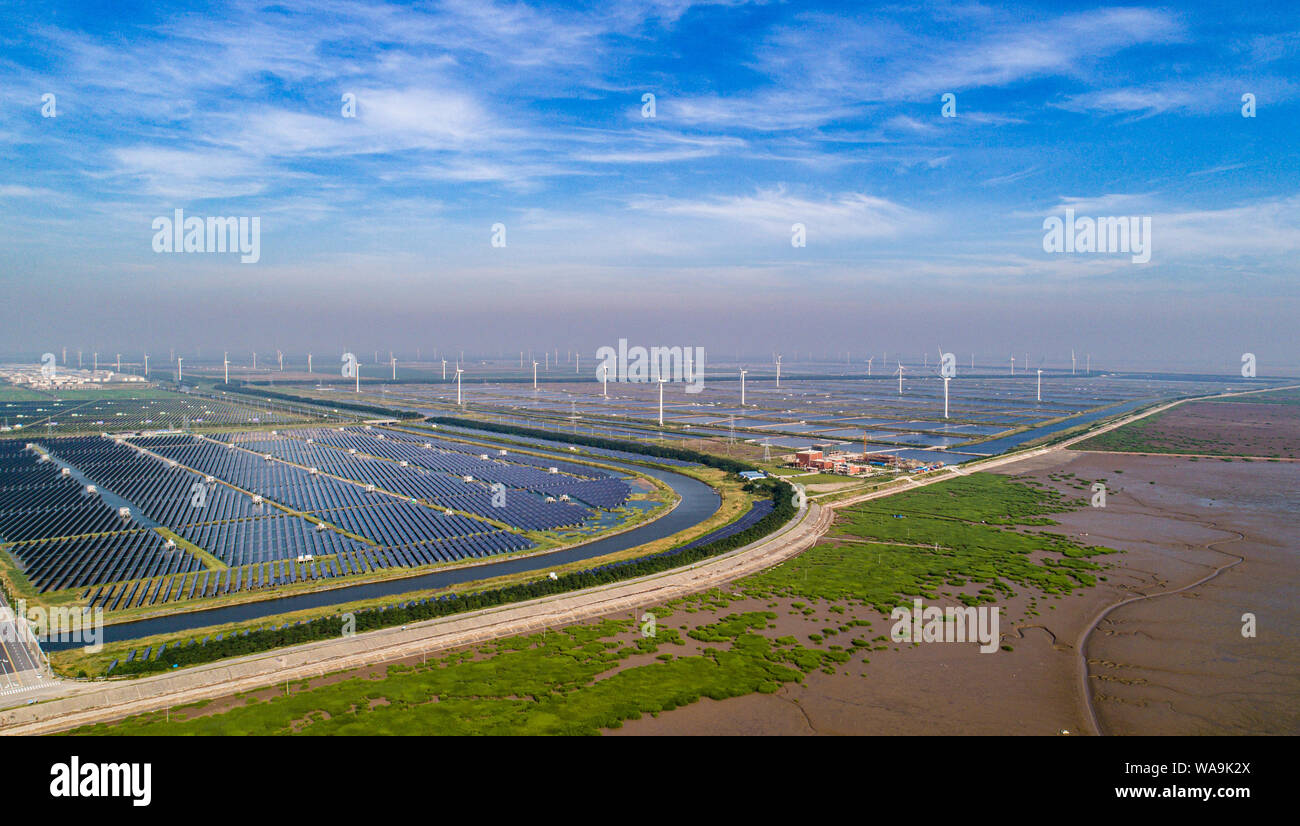 Chinese workers install solar panels at a photovoltaic power station in ...