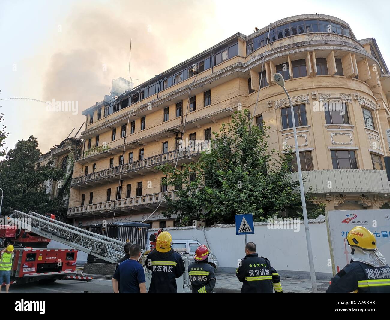 Chinese firefighters spray water to distinguish the fire after a fire ...