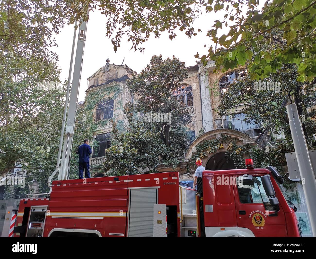 Chinese firefighters spray water to distinguish the fire after a fire ...