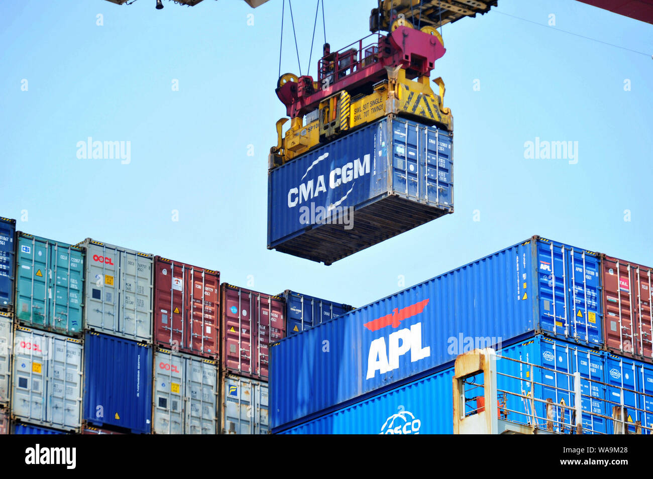 --FILE--A crane vehicle lifts a container to be shipped abroad from a ...