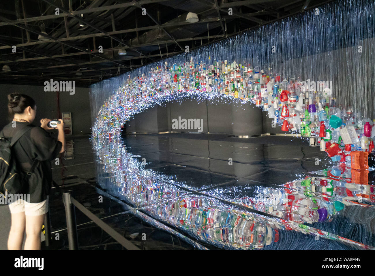 An art installation made of hundreds of plastic bottles is displayed ...