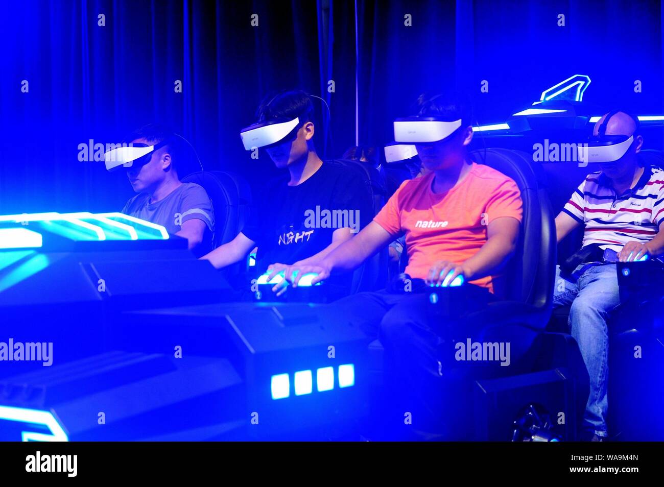 --FILE--Visitors wearing VR devices as they compete in an e-sports game ...