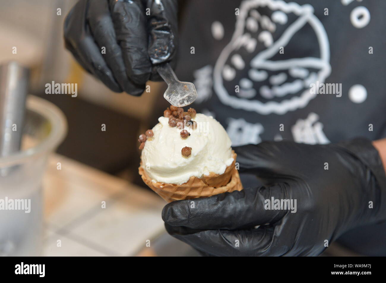 A tourist shows an ice cream added with Sichuan pepper at a store in ...