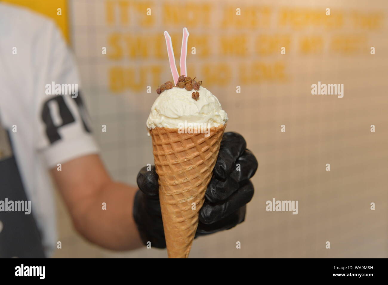 A tourist shows an ice cream added with Sichuan pepper at a store in ...
