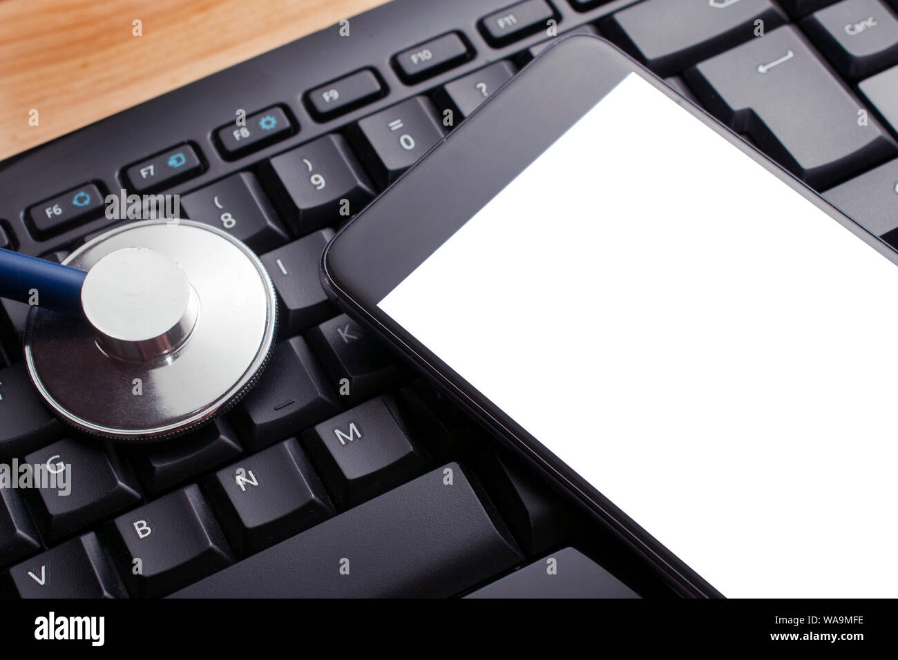 Healthcare concept: a blank screen smartphone and a stethoscope on a ...