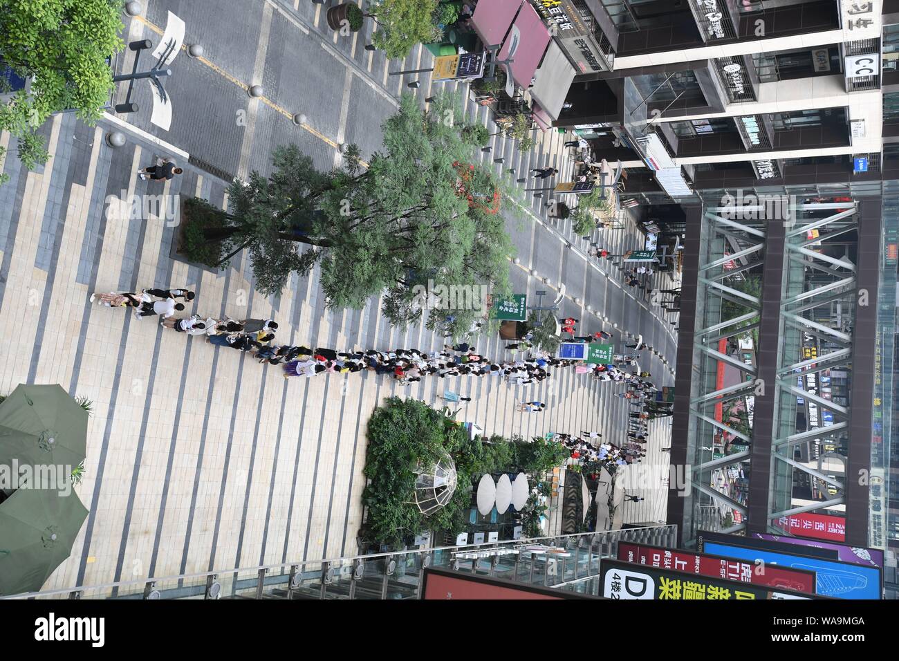 Chinese fans wait in a long queue in front of a milk tea store operated ...