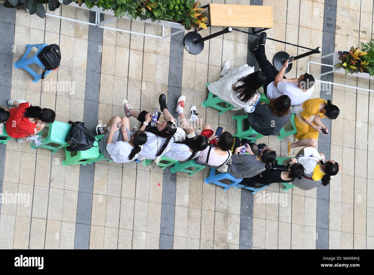 Chinese fans wait in a long queue in front of a milk tea store operated ...