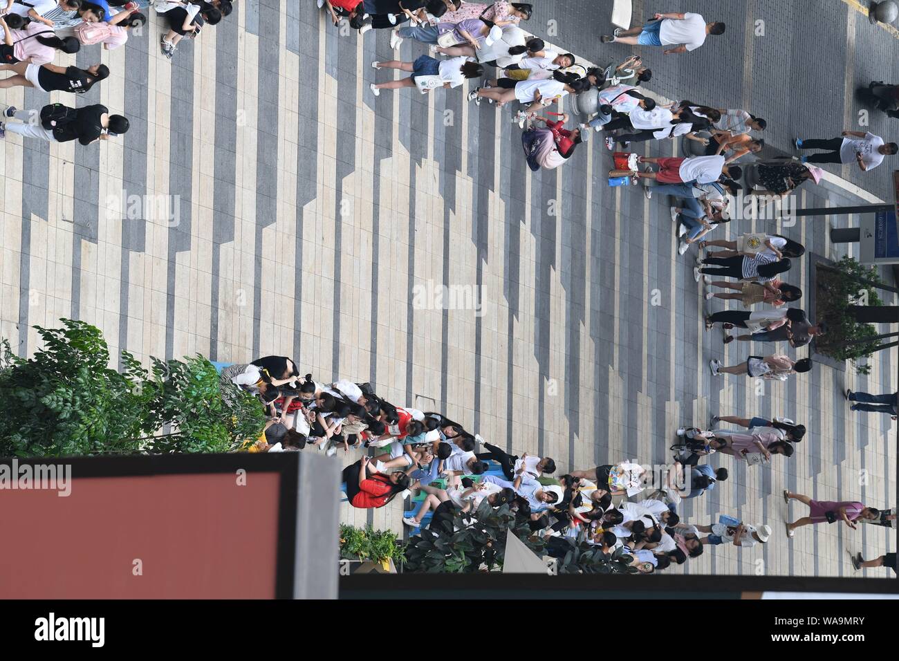 Chinese fans wait in a long queue in front of a milk tea store operated ...