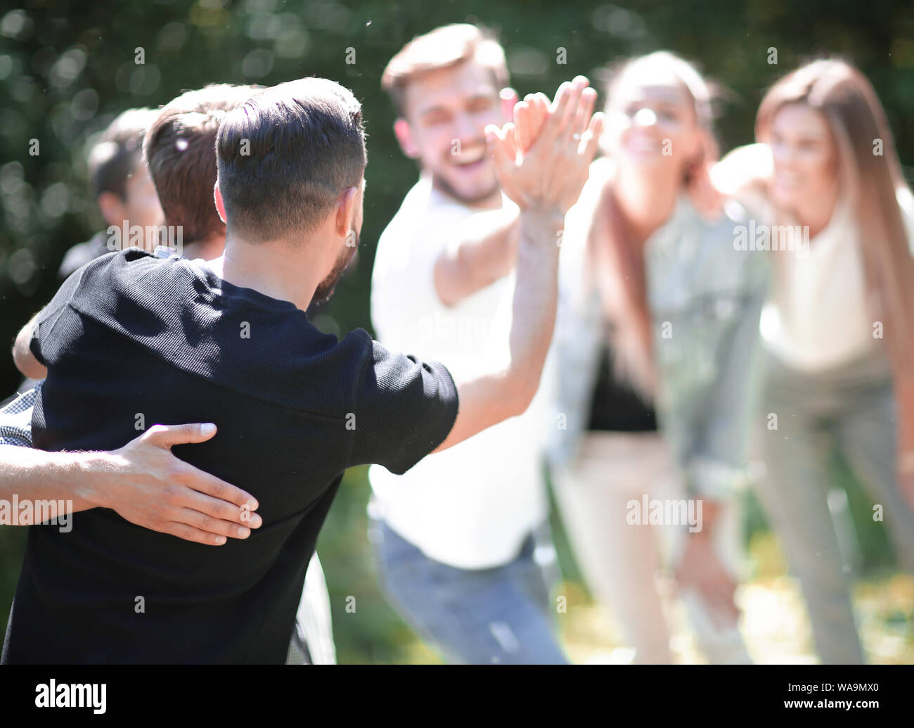 group of friends giving each other a high five Stock Photo - Alamy