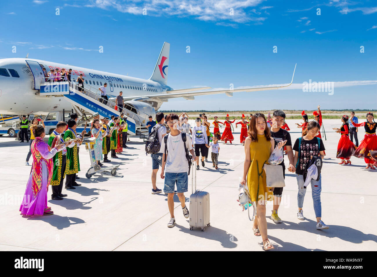 Passengers deboard an Airbus A319 jet plane of China Eastern Airlines ...