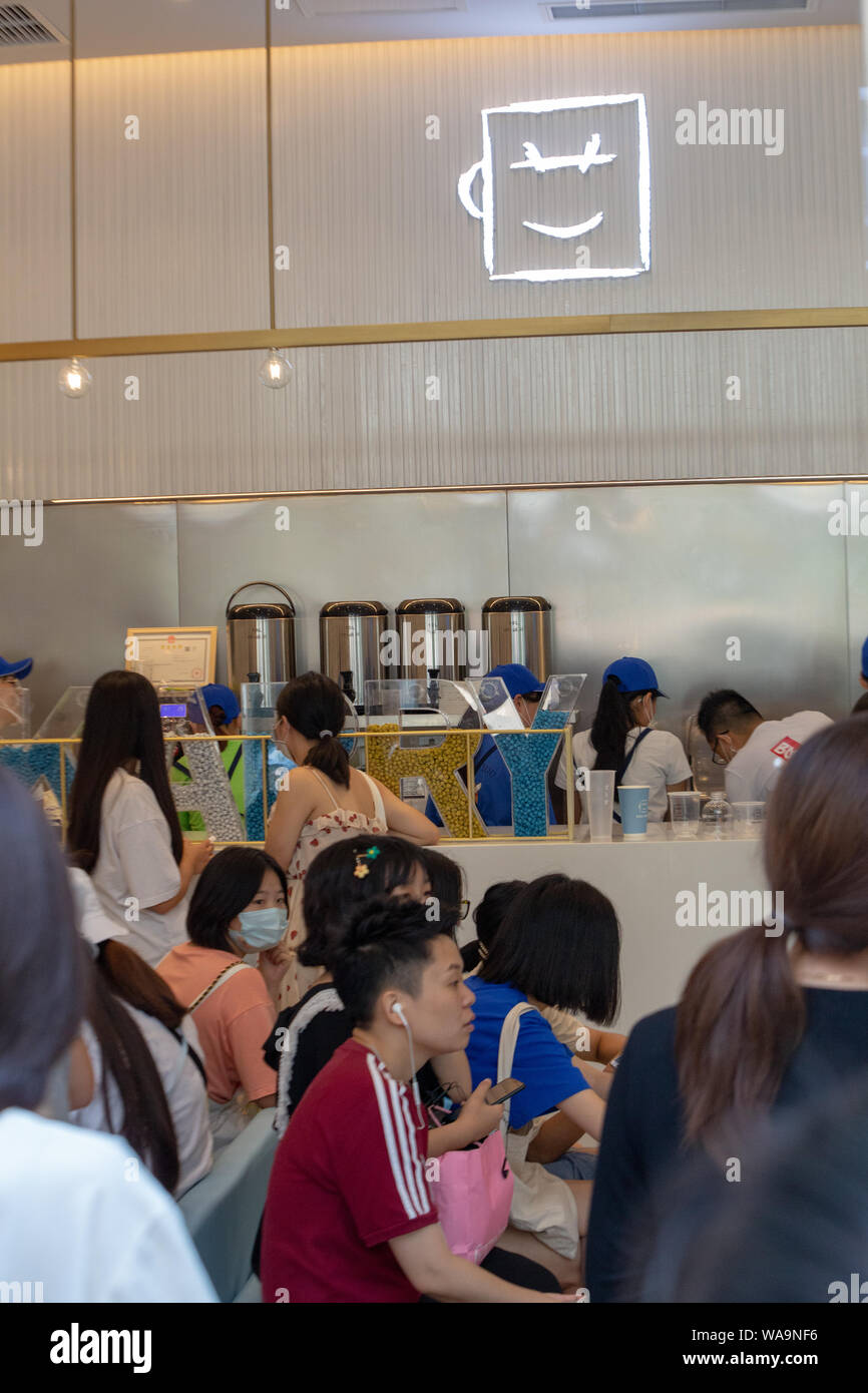 Chinese fans wait in a long queue in front of a milk tea store operated by parents of singer and ...