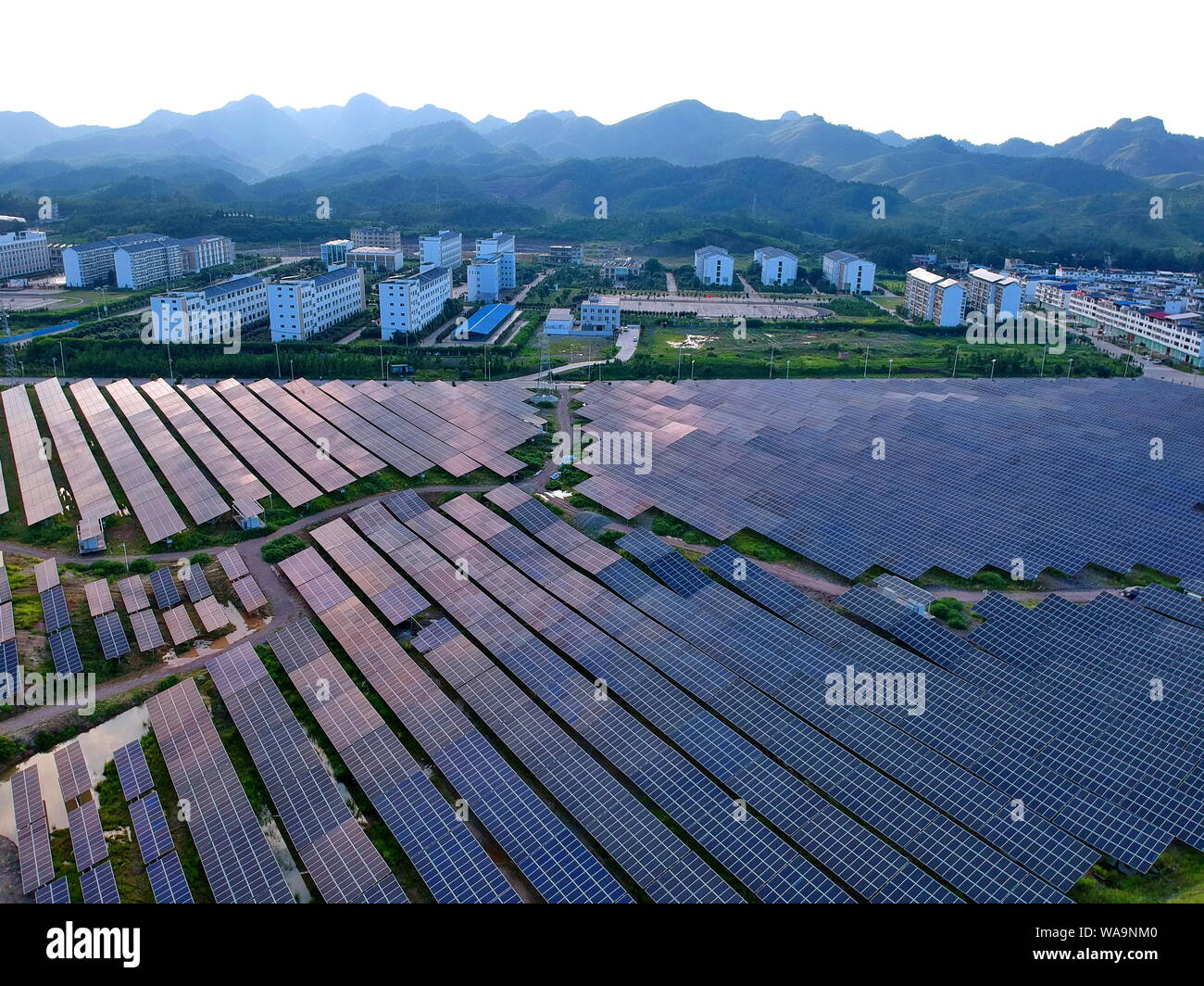 --FILE--Aerial view of arrays of solar panels installed around the ...