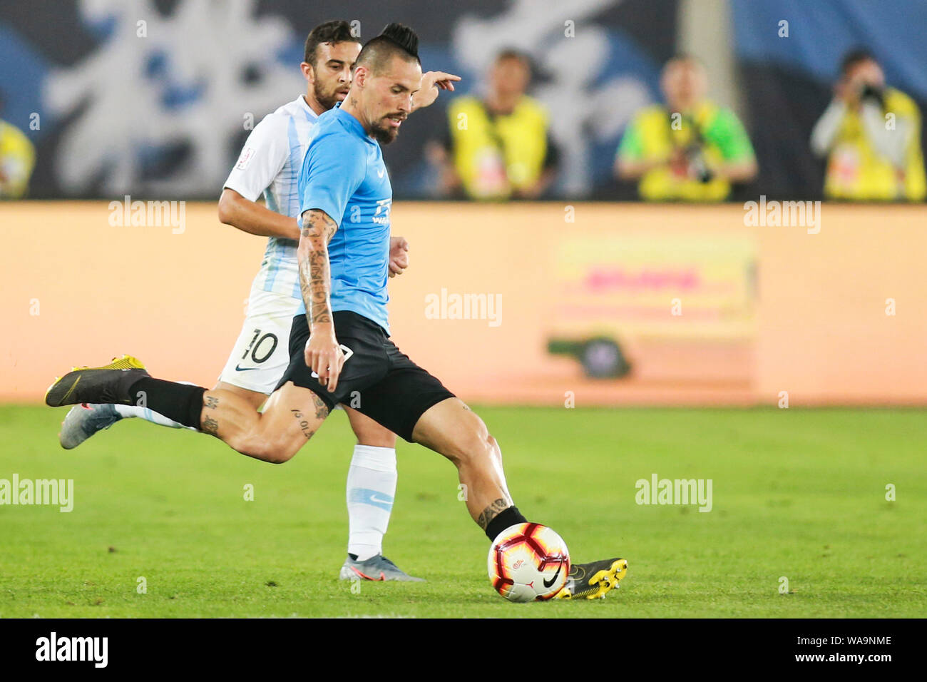 Slovak football player Marek Hamsik, right, of Dalian Yifang passes the ...