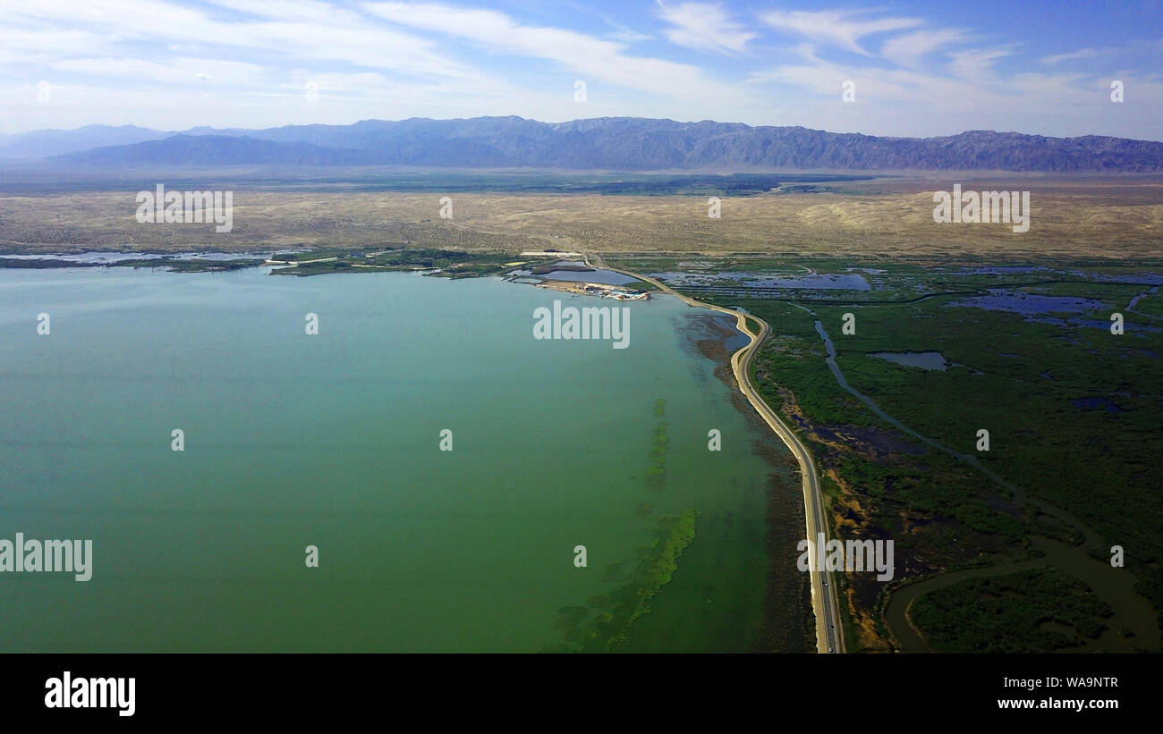 Aerial view of a highway around the Bosten Lake, one of the largest ...