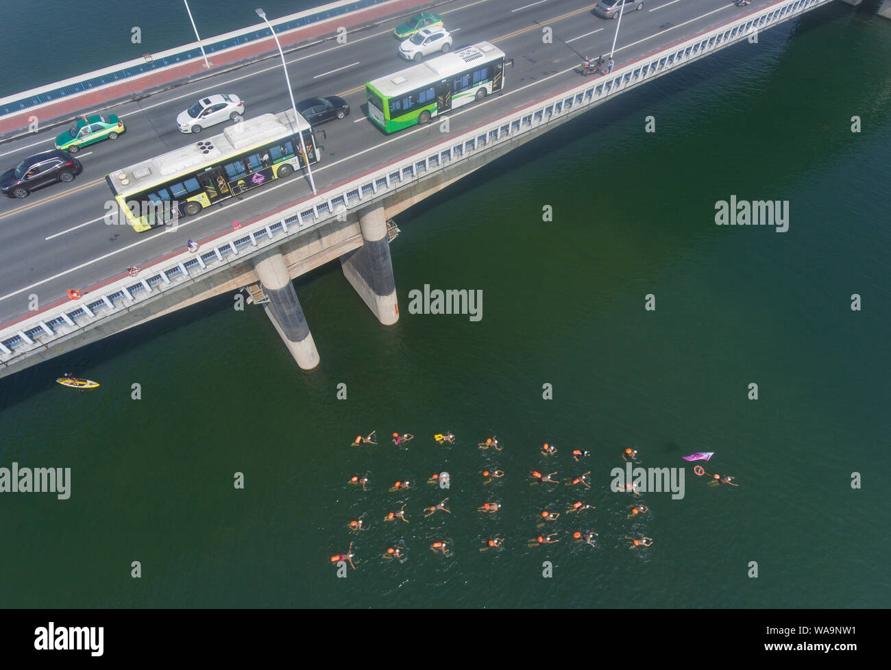Participants compete in a swimming challenge to swim across the Han ...