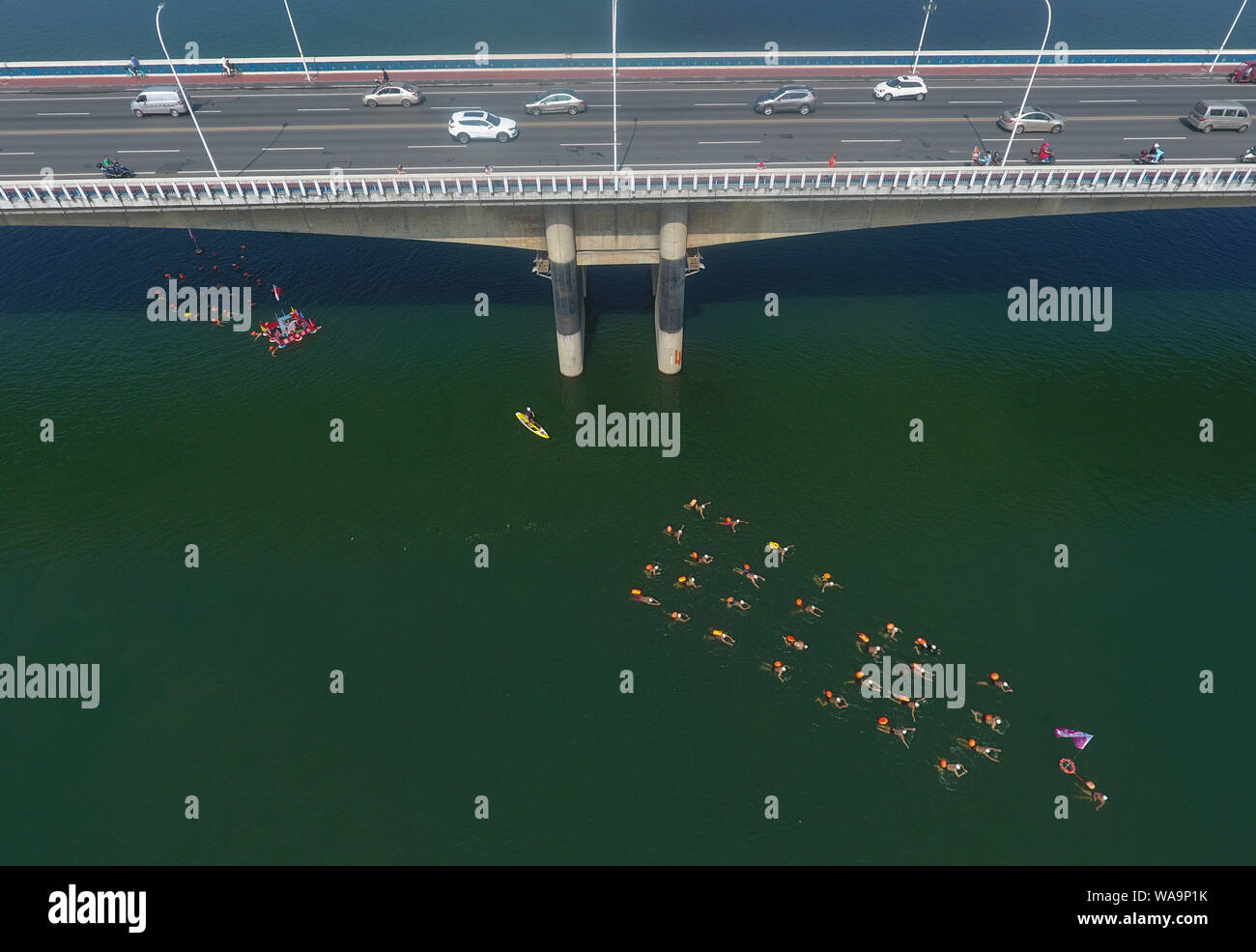 Participants compete in a swimming challenge to swim across the Han ...